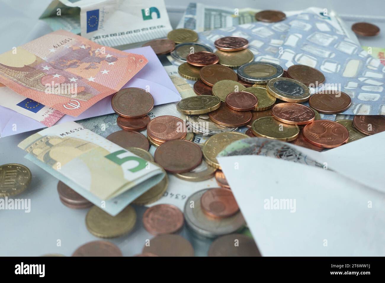 09.11.2023, Berlin, DE - Geldscheine und Muenzen in einer Spendenbox ...