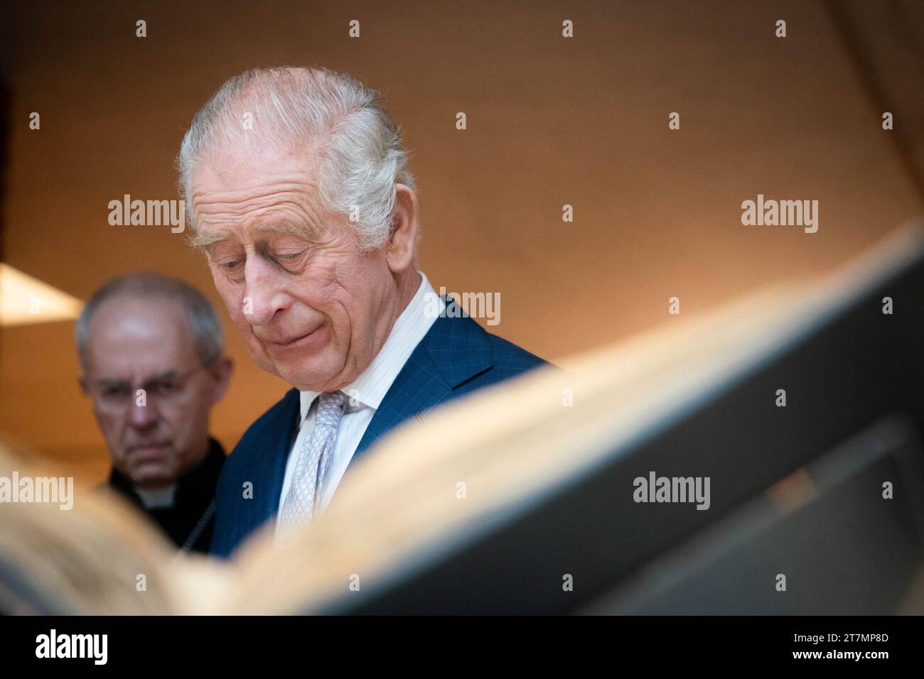 Britain's King Charles III looks at religious books during a reception ...