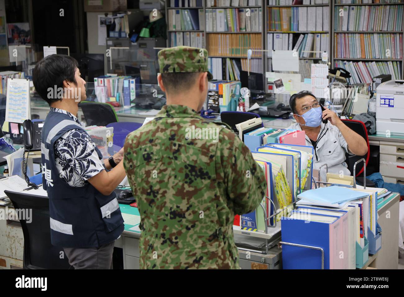 Officials of Okinawa Government and a member of JSDF gather information ...