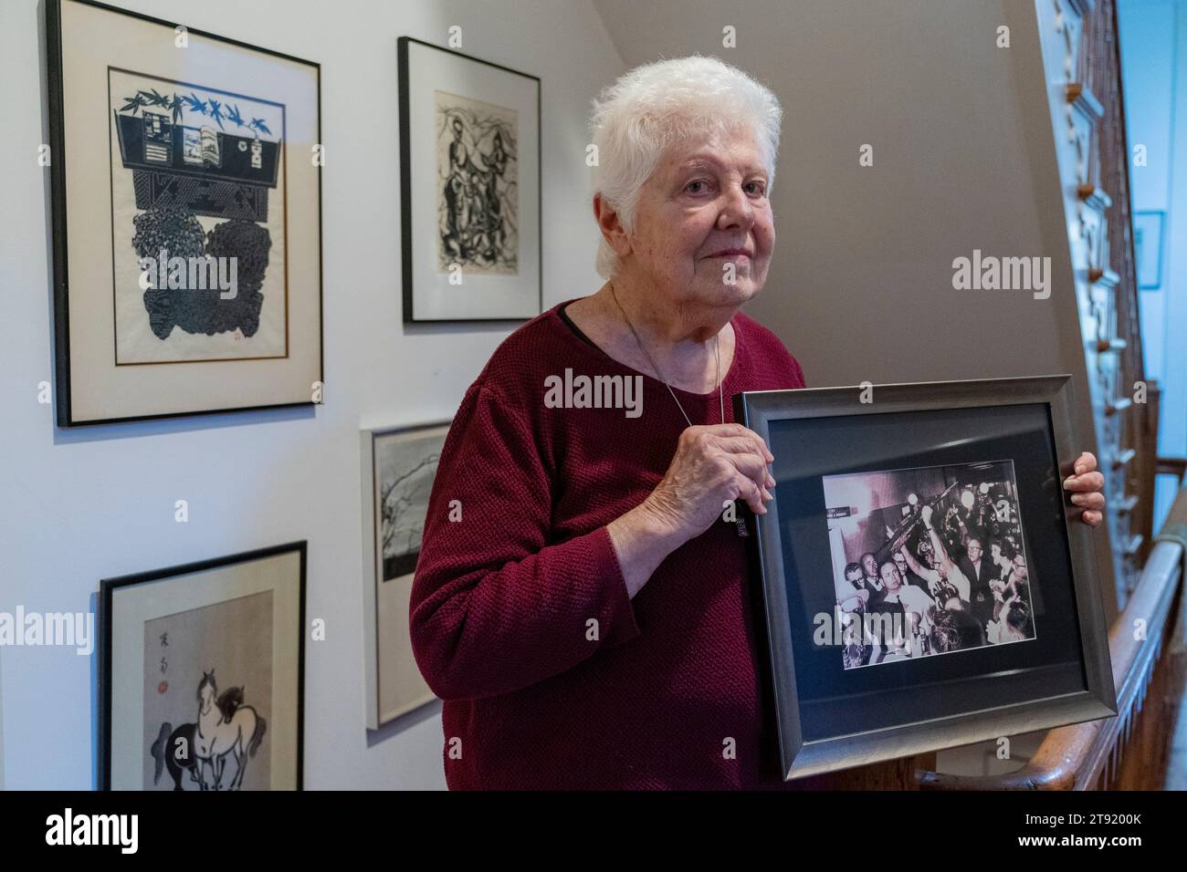 Peggy Simpson holds a photograph of law enforcement carrying Lee Harvey ...