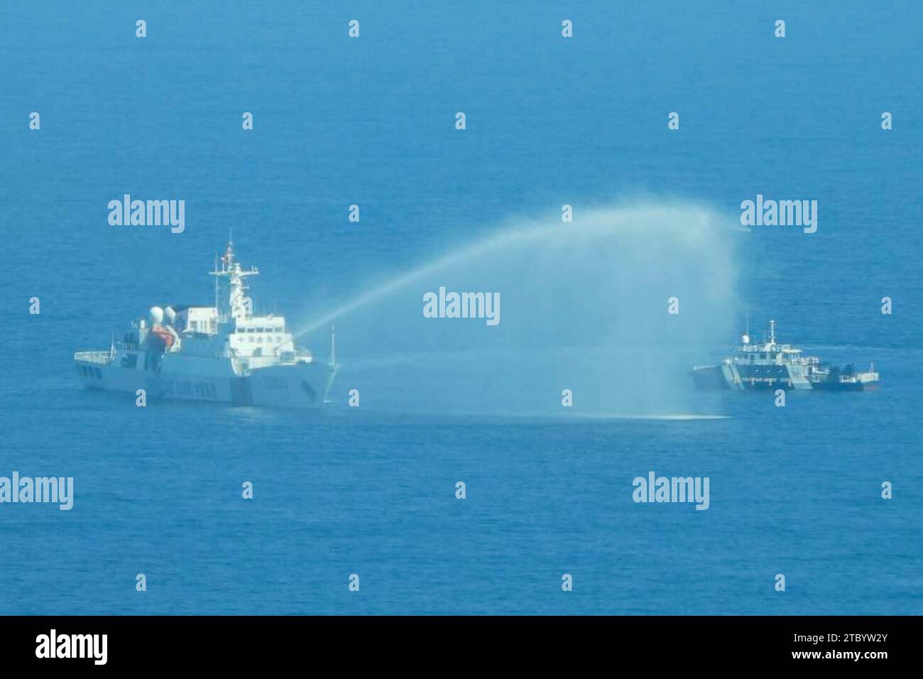 In this photo provided by the Philippine Coast Guard, a Chinese Coast Guard ship, left, uses its ...