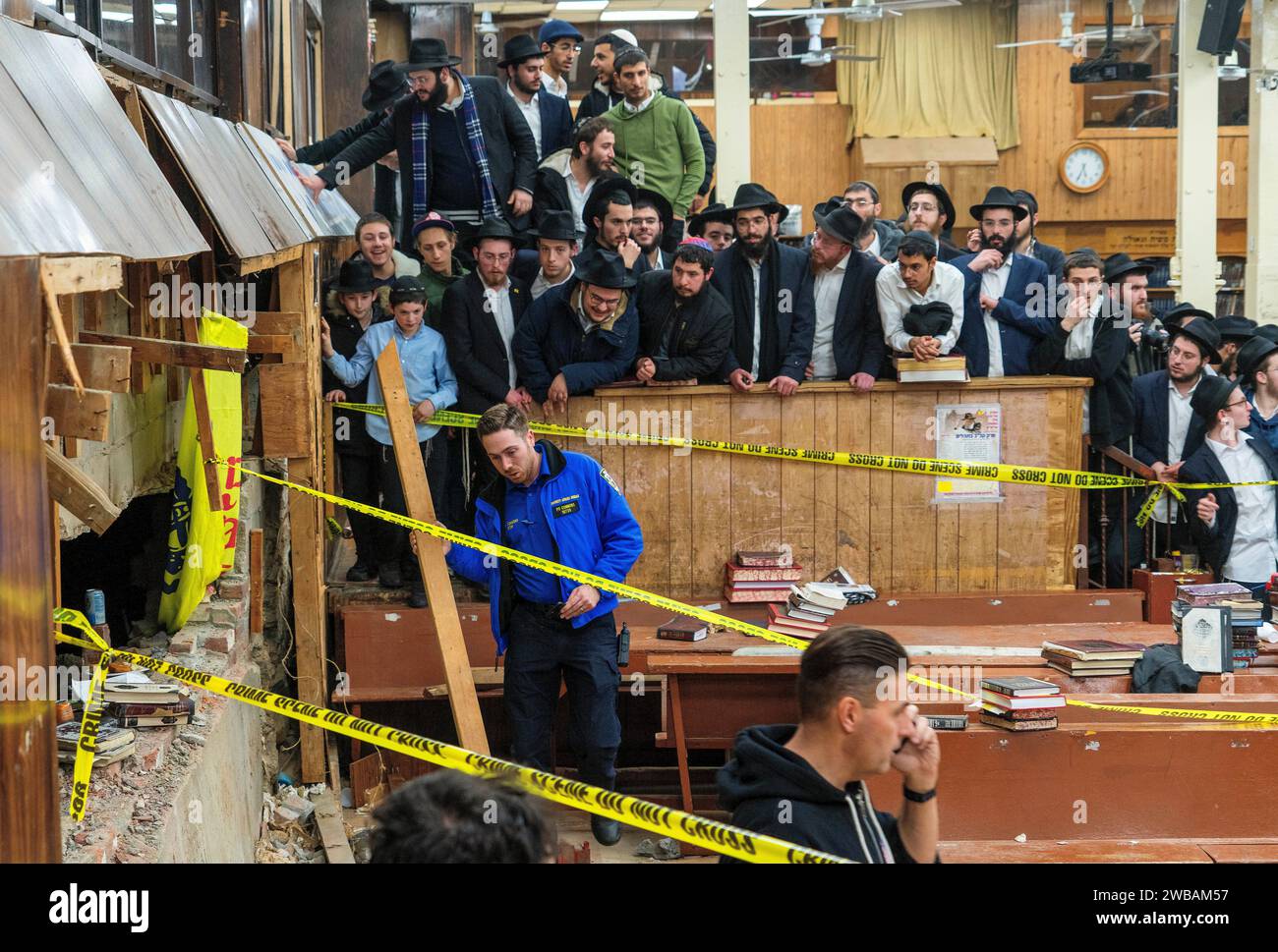 Hasidic Jewish students observe as law enforcement establishes a ...