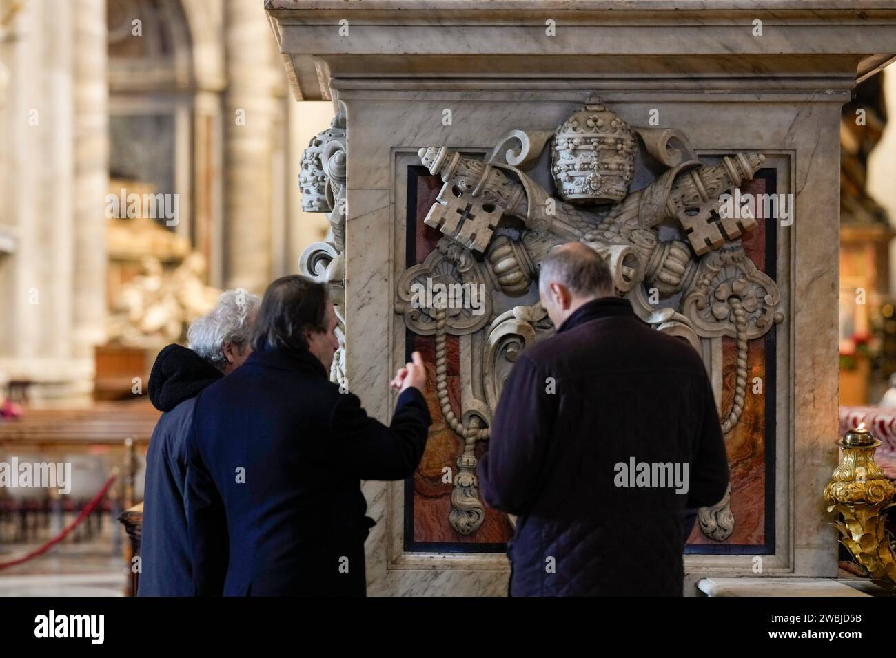 Workmen inspect the base of one of the columns of the 17th century ...