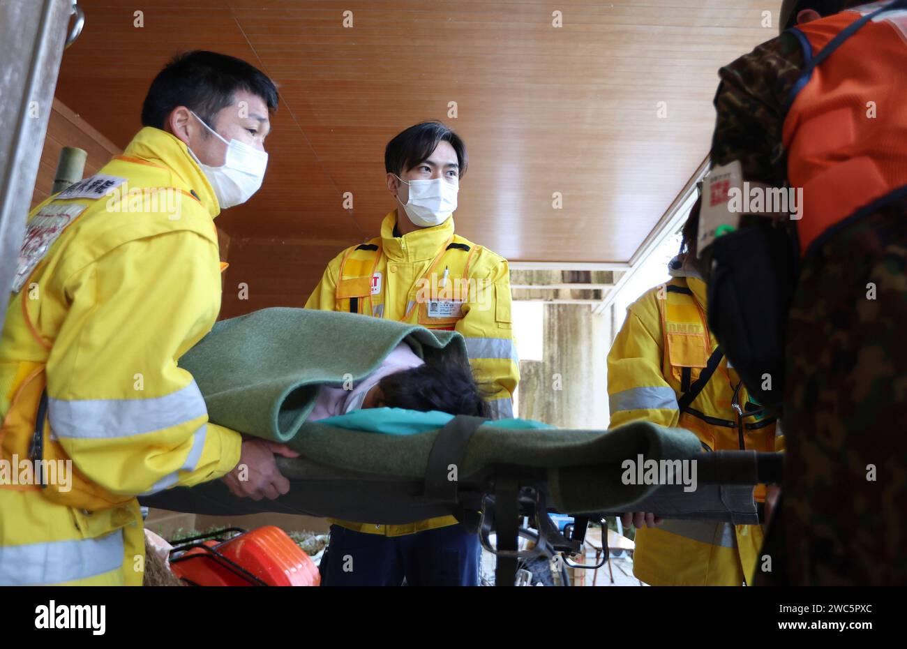 DMAT (Disaster Medical Assistance Team) and Japan Self-Defense Force members transport patients ...