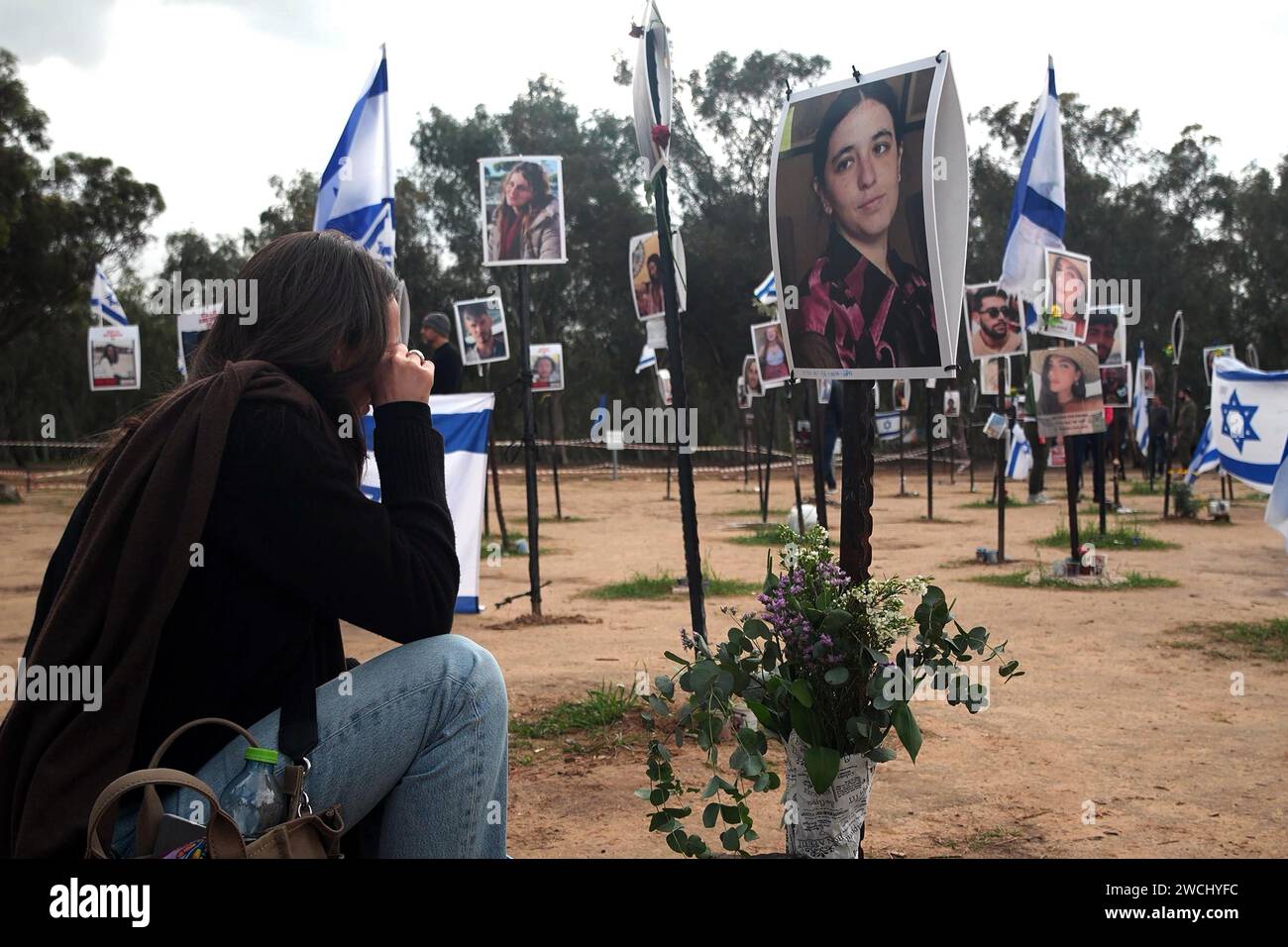 Eine junge israelische Frau weint, als sie neben einem Foto ihres ...