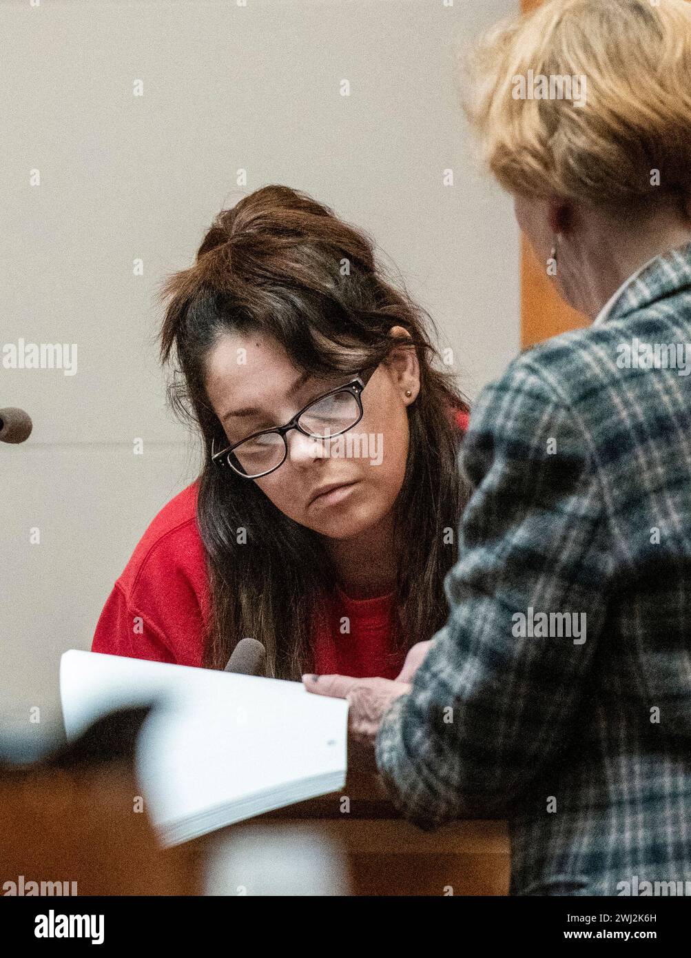 Kayla Montgomery reviews documents while testifying during the trial of ...