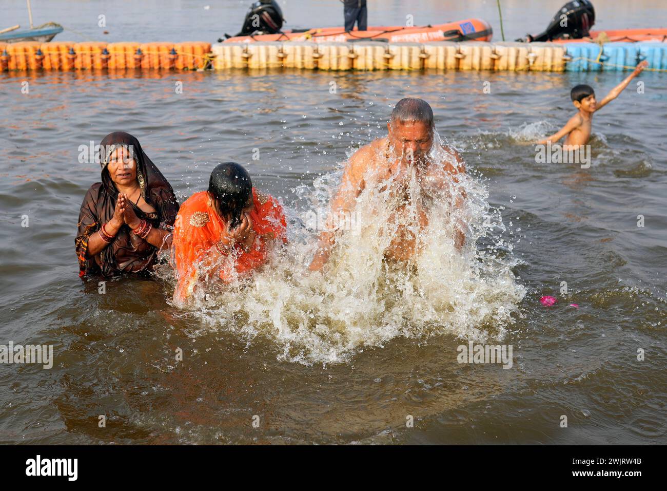 Hindu devotees take a holy dip at the Sangam, the confluence of three ...