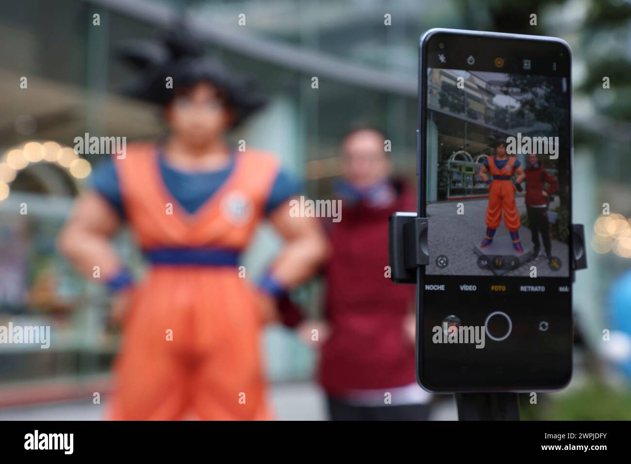 People take a photo with a statue of Son Goku, a protagonist of Dragon ...