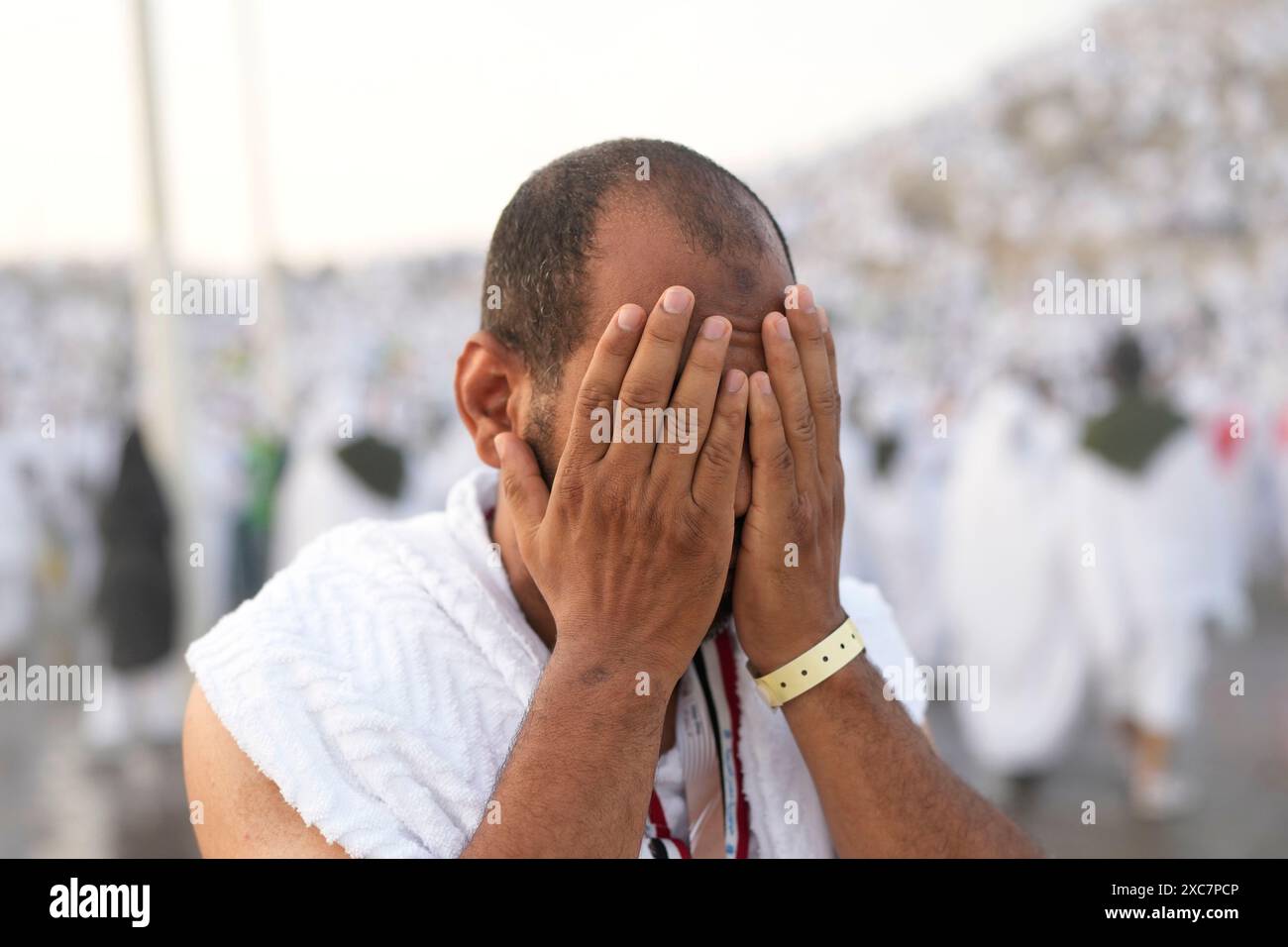 A Muslim pilgrim offers prayer at top of the rocky hill known as the ...