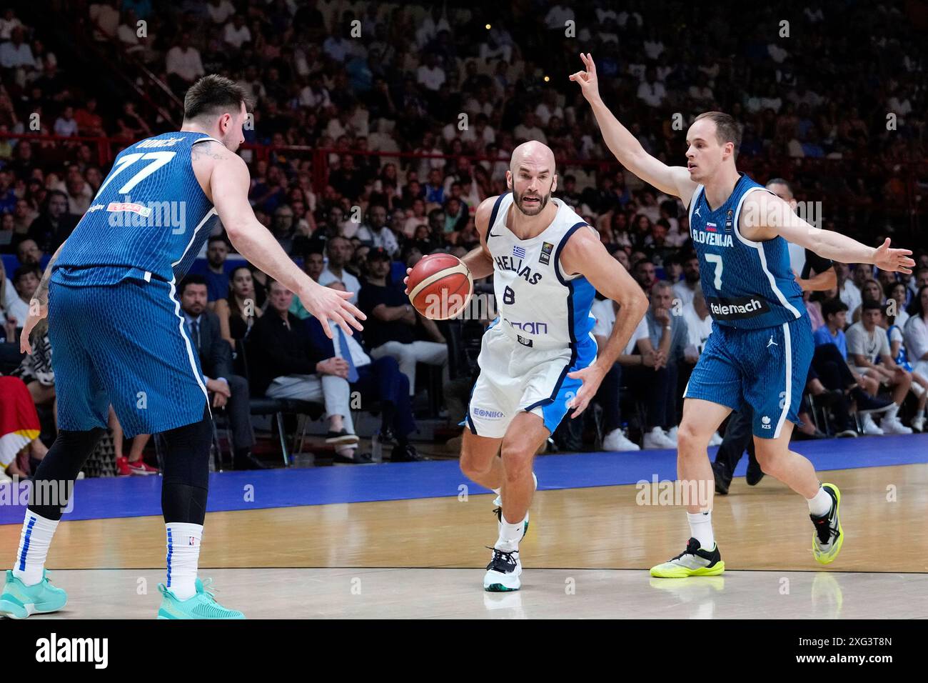 Greece's Nick Calathes controls the ball between Slovenia's Klemen ...