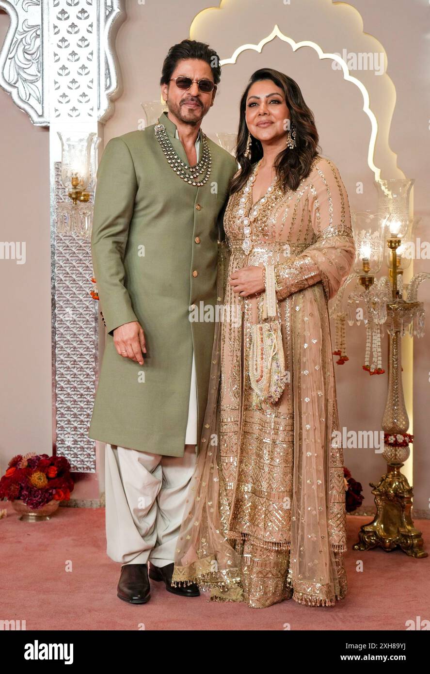 Bollywood actor Shah Rukh Khan poses for a photograph with his wife ...