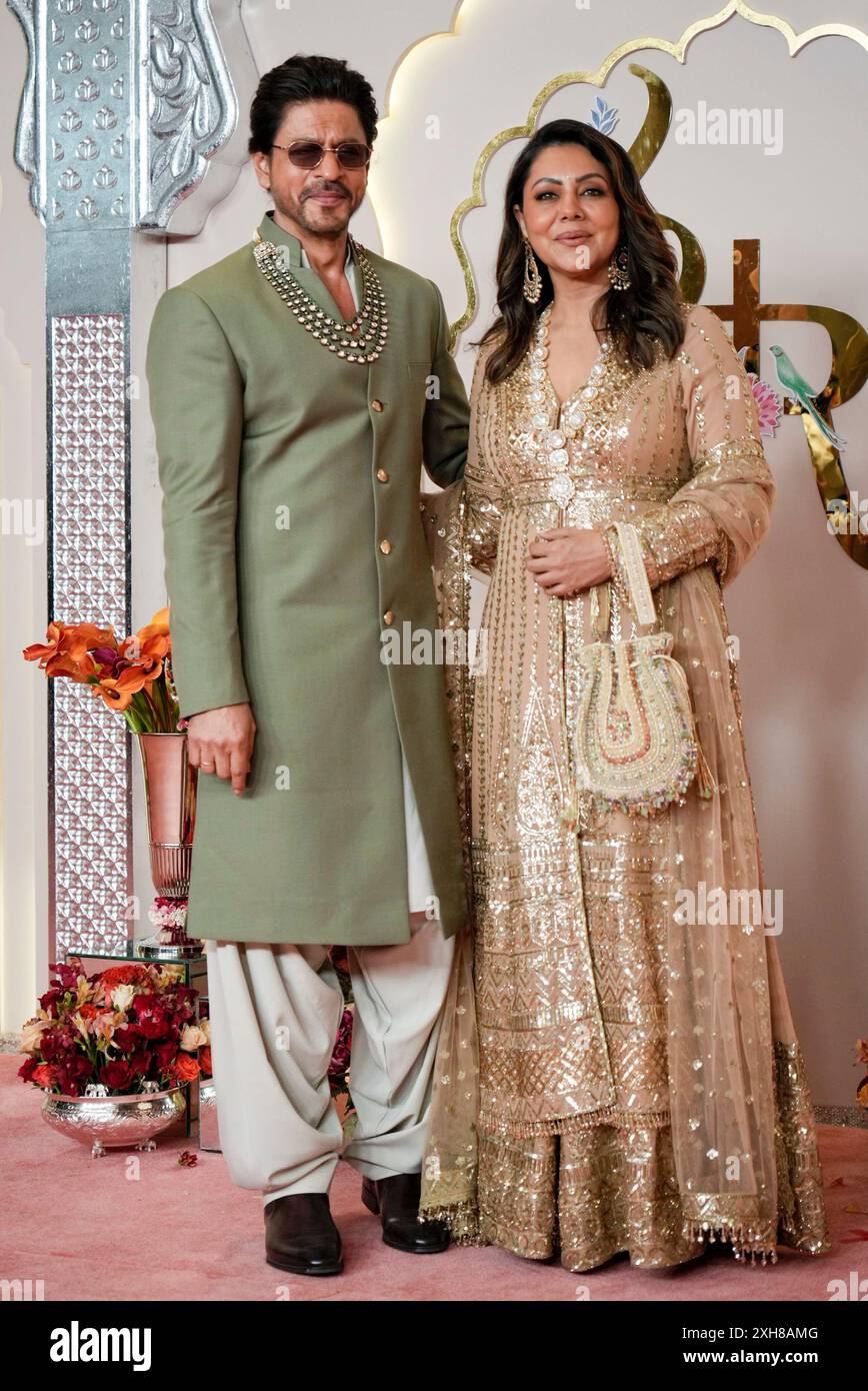 Bollywood actor Shah Rukh Khan poses for a photograph with his wife ...