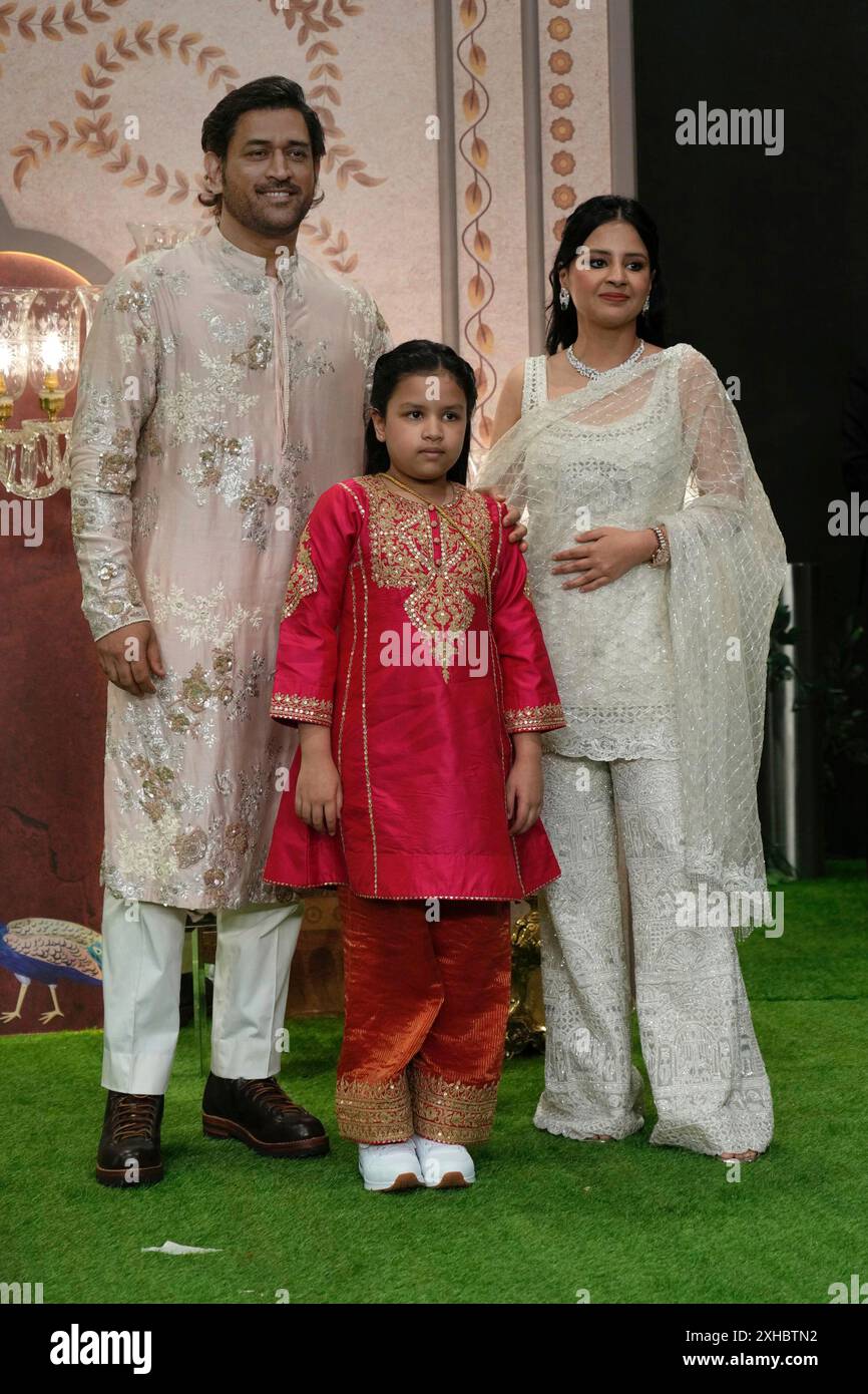 Former Indian cricketer MS Dhoni poses for a photograph with his wife ...