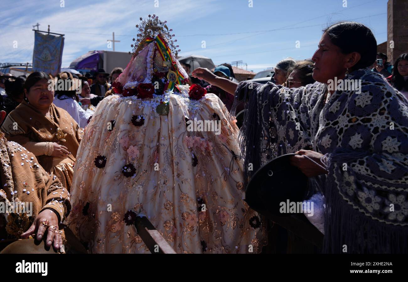 A devotee reaches out to touch the tiny Virgin Mary of the Litanies ...