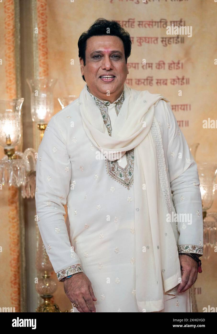 Indian actor Govinda poses for a photograph at the wedding reception of ...