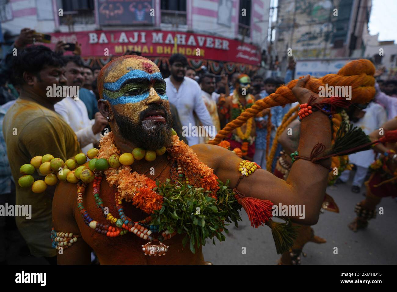 A man dressed as Pothuraju, a mythical character, performs rituals ...