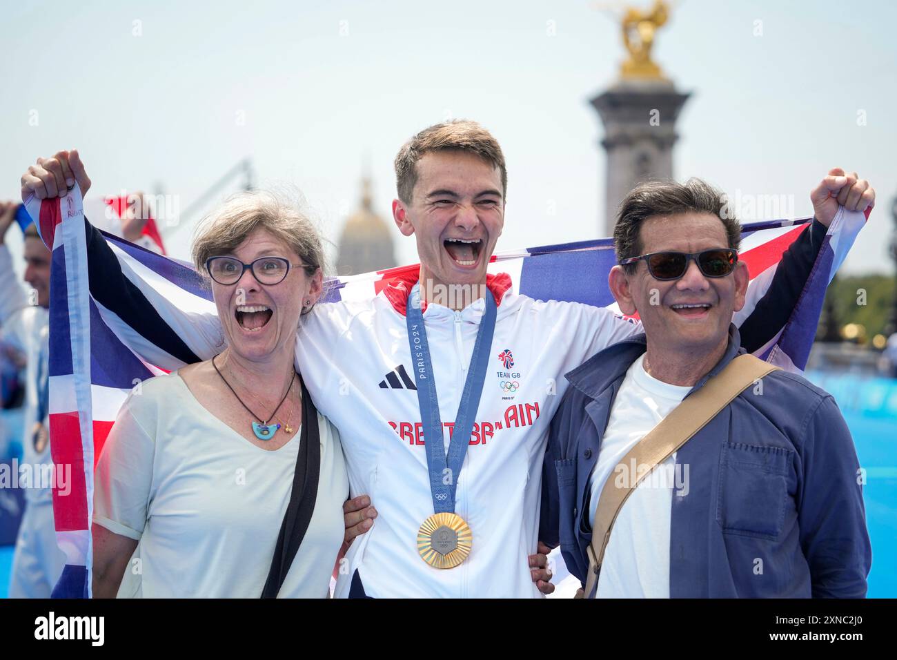 Gold medalist Britain's Alex Yee poses with his parents Emma Amos Yee ...