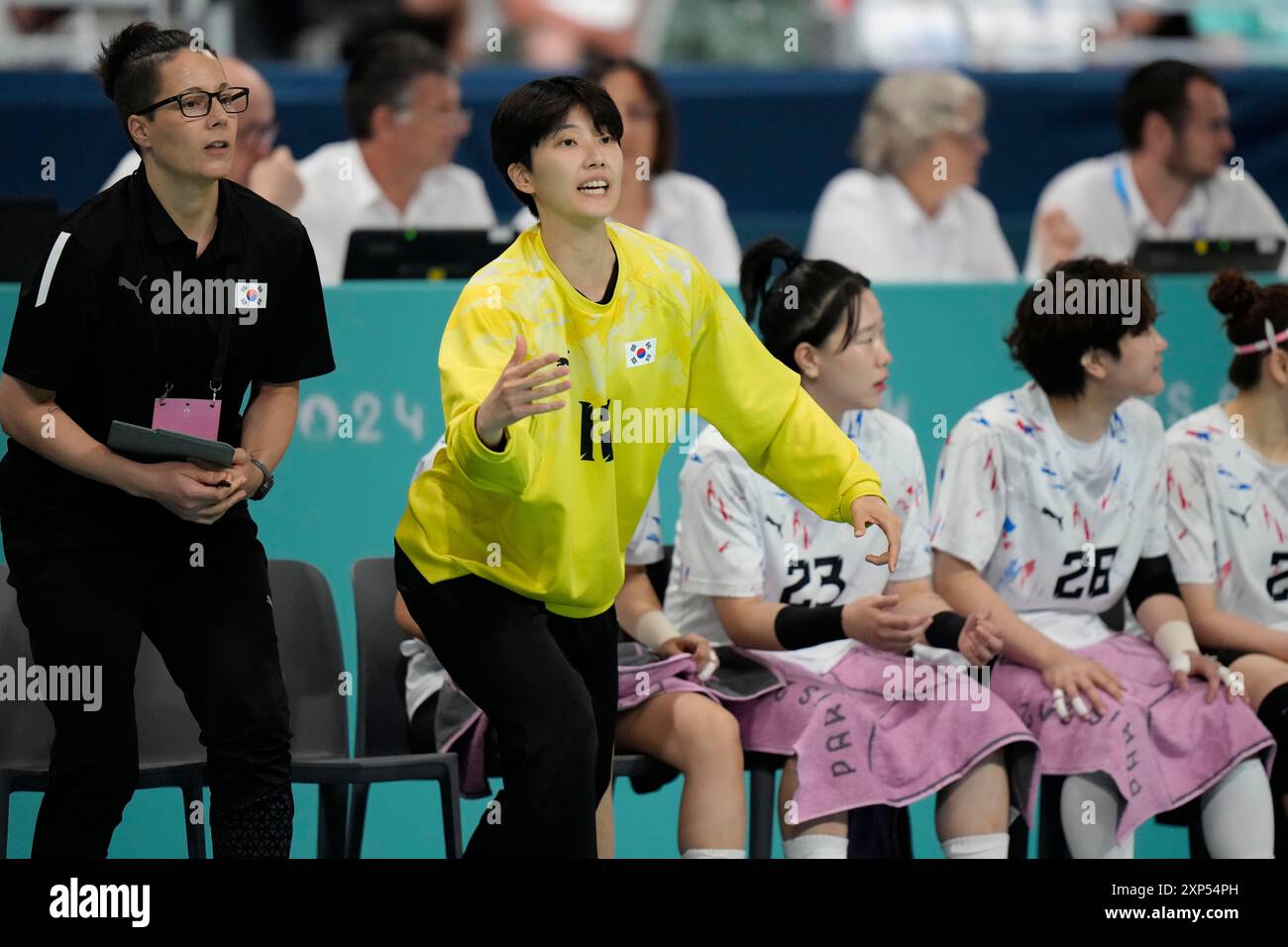 Members of South Korea's team react on the bench during a women's ...