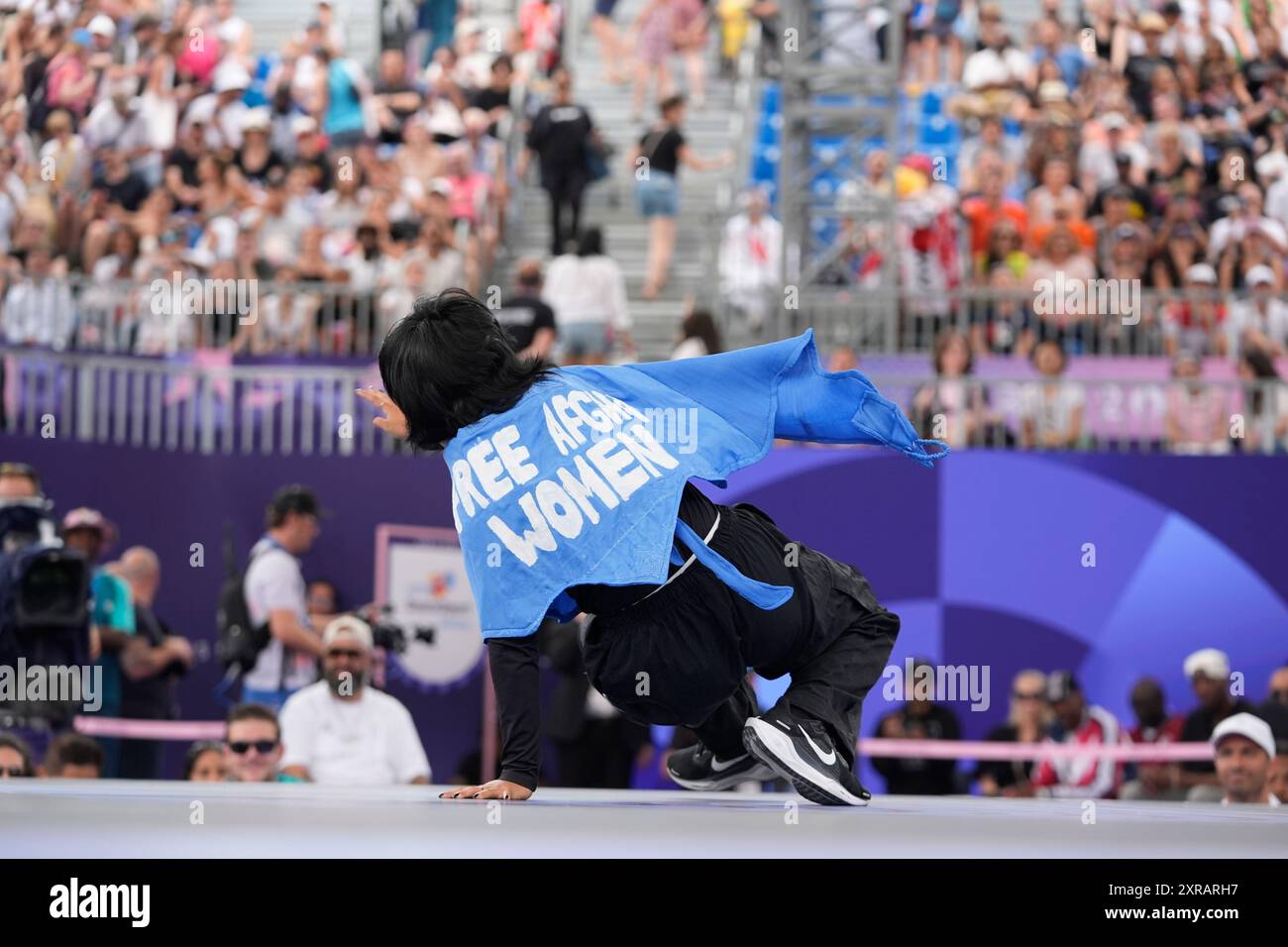 Refugee Team's Manizha Talash, known as Talash wears a cape which reads ...