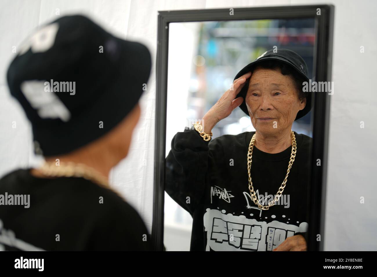 Park Jeom-sun, 82, leader of Suni and the Seven Princesses, adjusts her ...