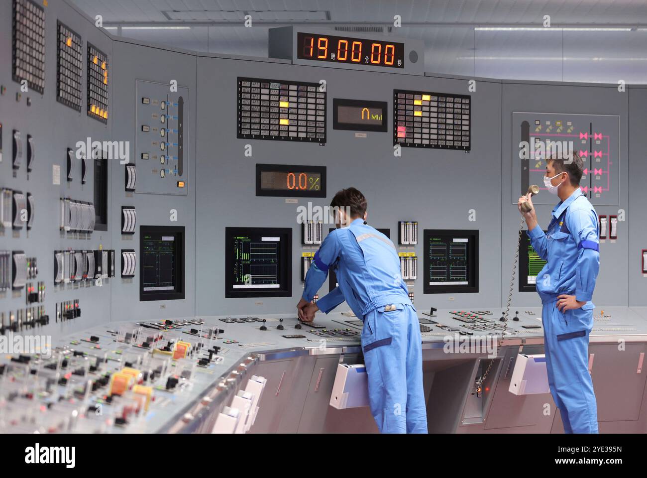 Operators start the reactor at the central control room of the Onagawa ...