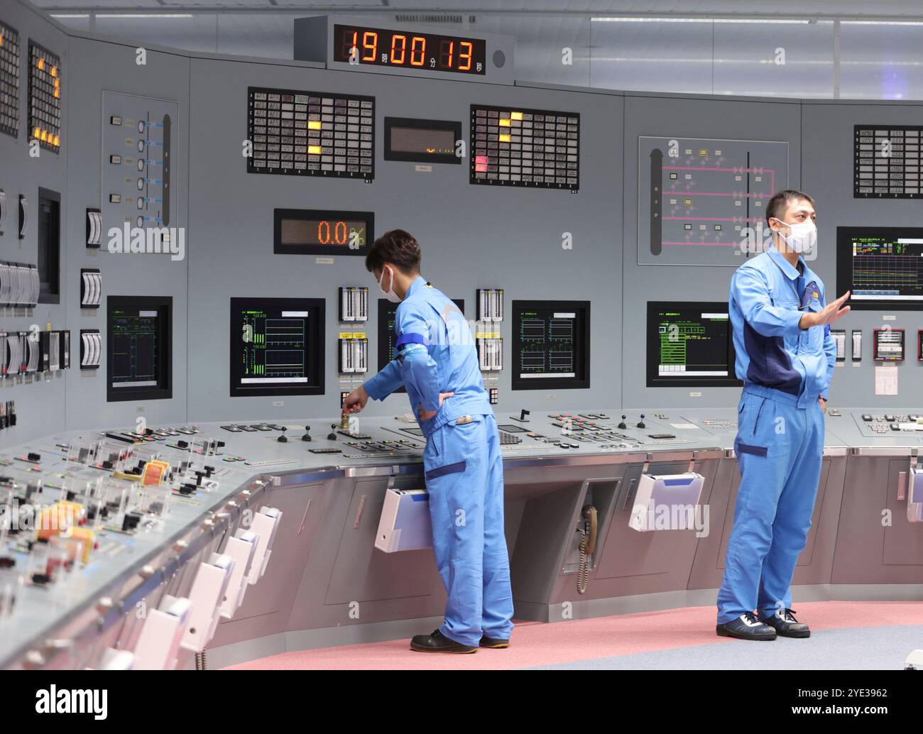 Operators start the reactor at the central control room of the Onagawa ...