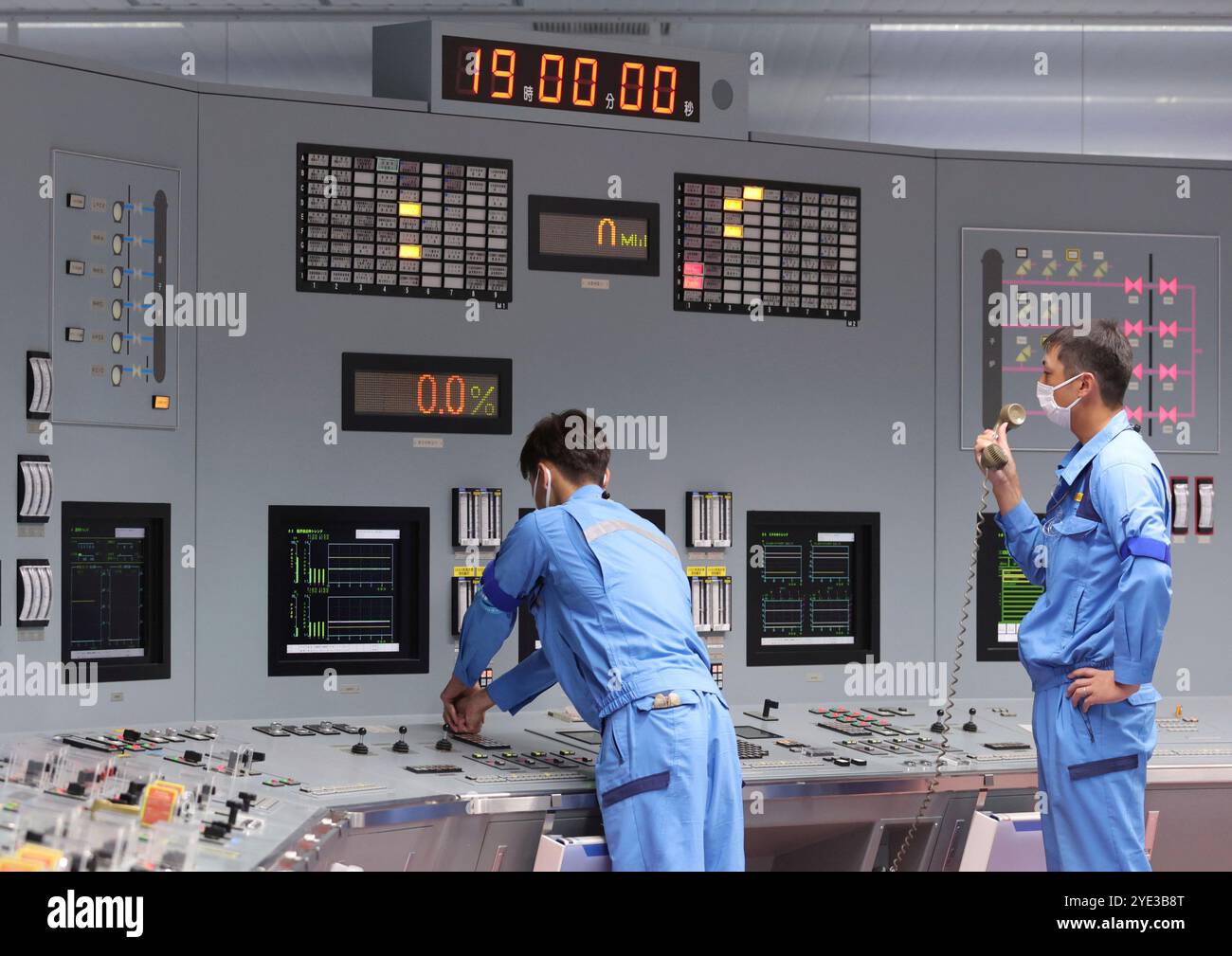 Operators start the reactor at the central control room of the Onagawa ...