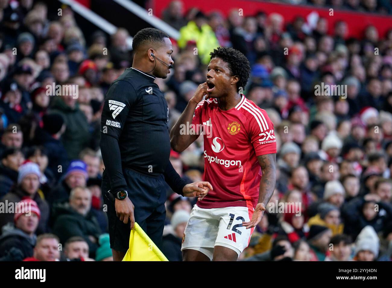 Manchester United's Tyrell Malacia argues with line referee Akil Howson ...