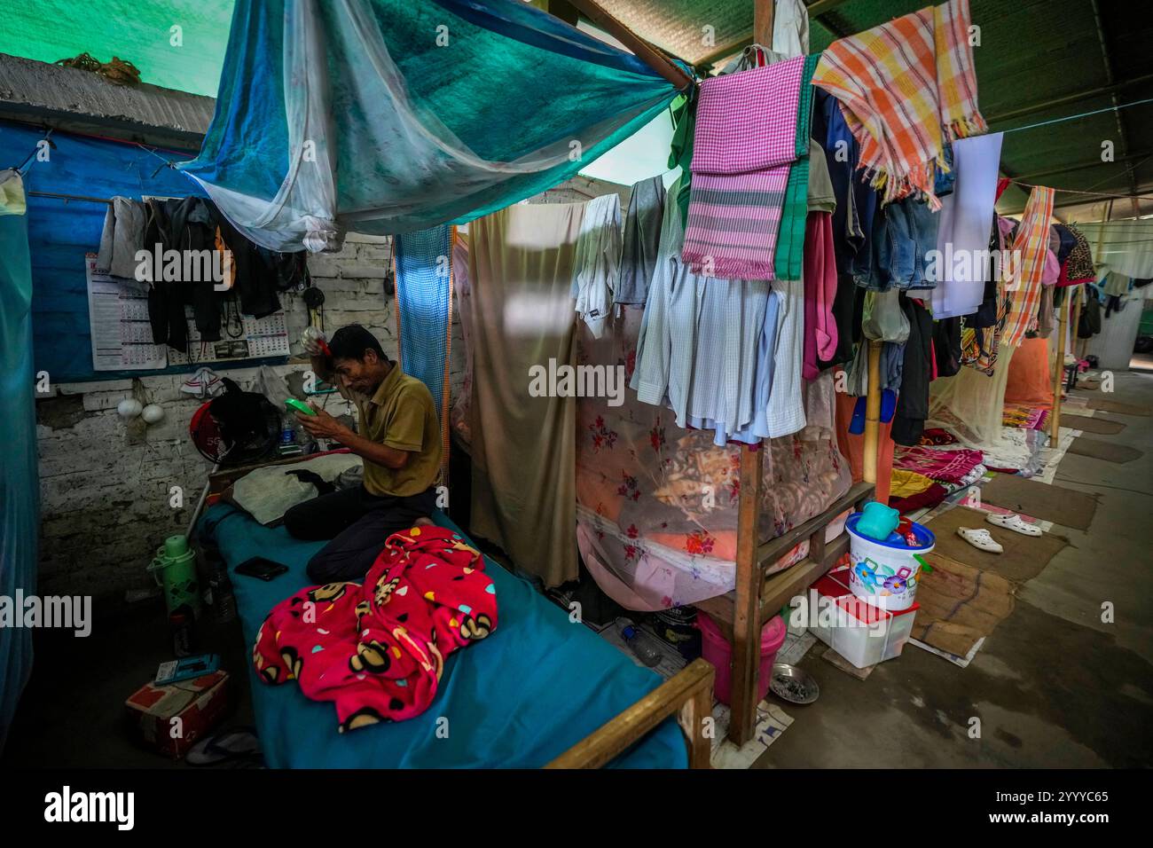 A Meitei man combs his hair in a relief camp in Imphal, Manipur, Monday ...