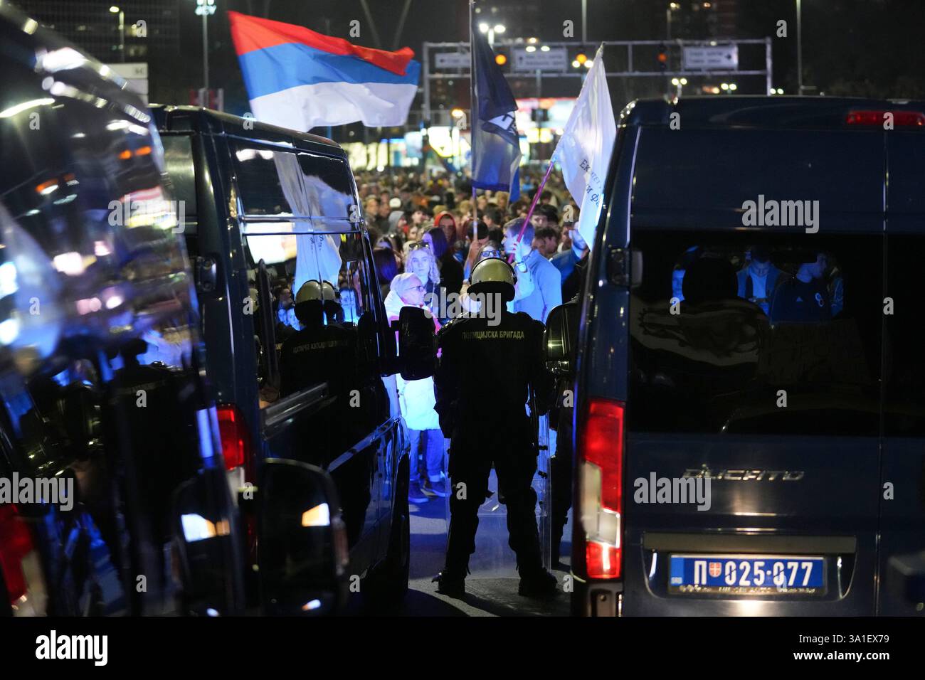Serbian police officers block a bridge as students and citizens march ...