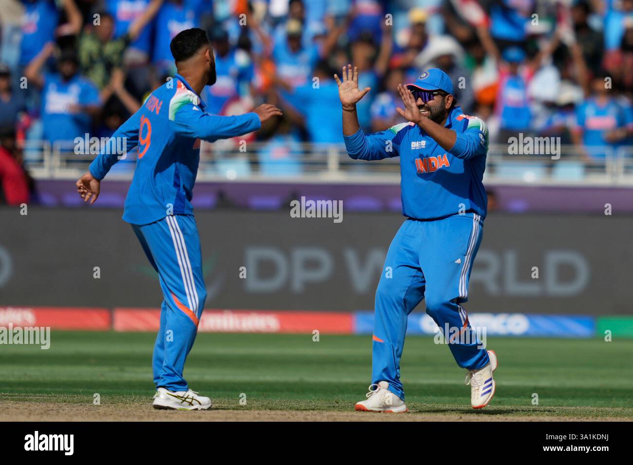 India's Varun Chakravarthy, left, celebrates with captain Rohit Sharma ...