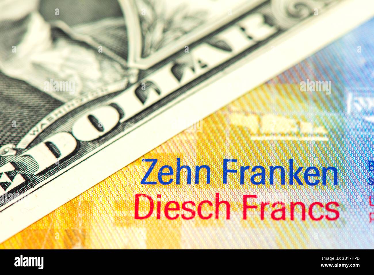 Ein Dollarschein liegt auf Schweizer Franken ein Dollarschein liegt auf ...