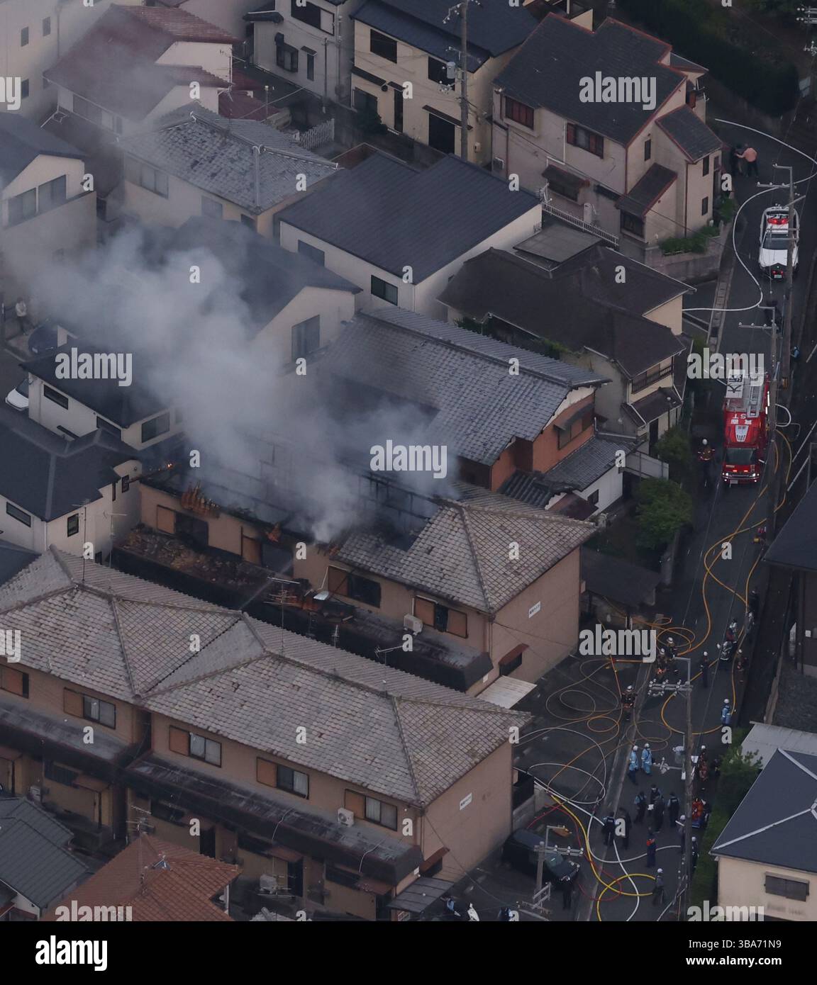 An aerial photo shows the scene of a house fire, where a teenage man ...