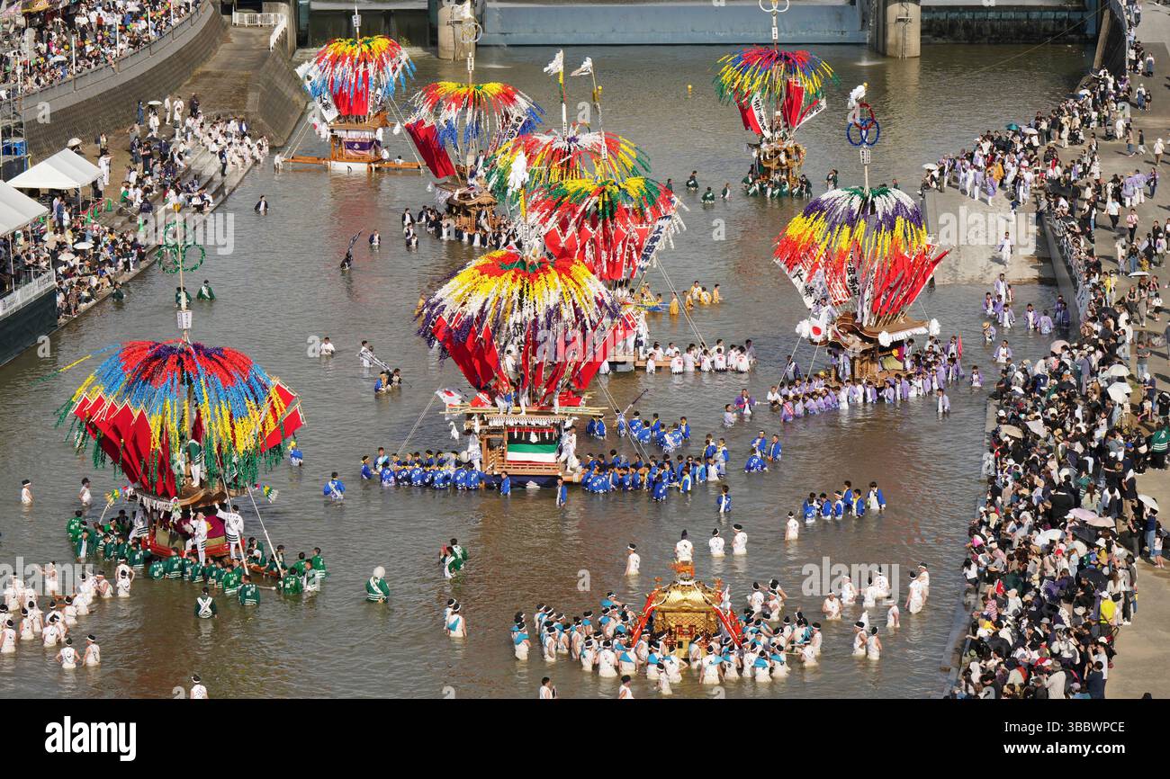 Colorful Yamakasa valiantly cross the Hikoyama River during a Japanese ...