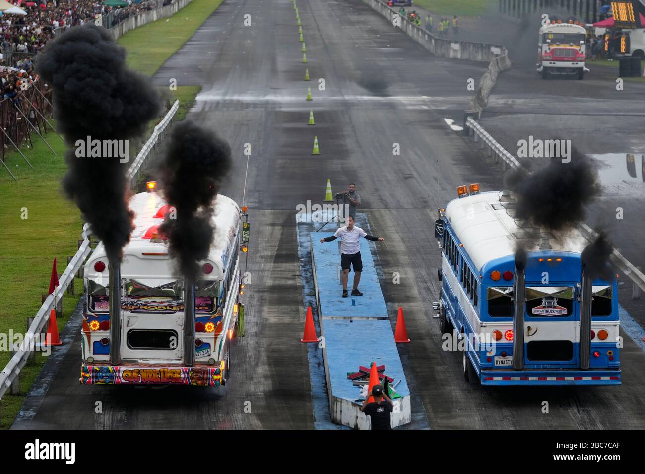 Red Devil buses race at a track in La Chorrera, Panama, Sunday, May 18 ...
