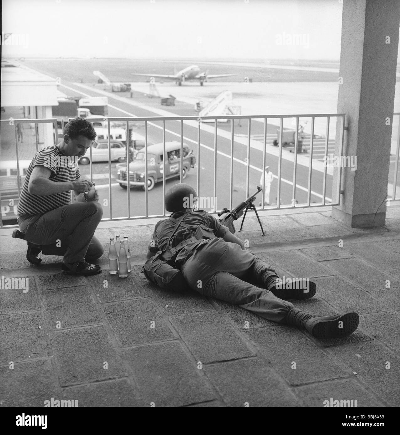 A Belgian paratrooper mans a light machine gun from an elevated vantage ...