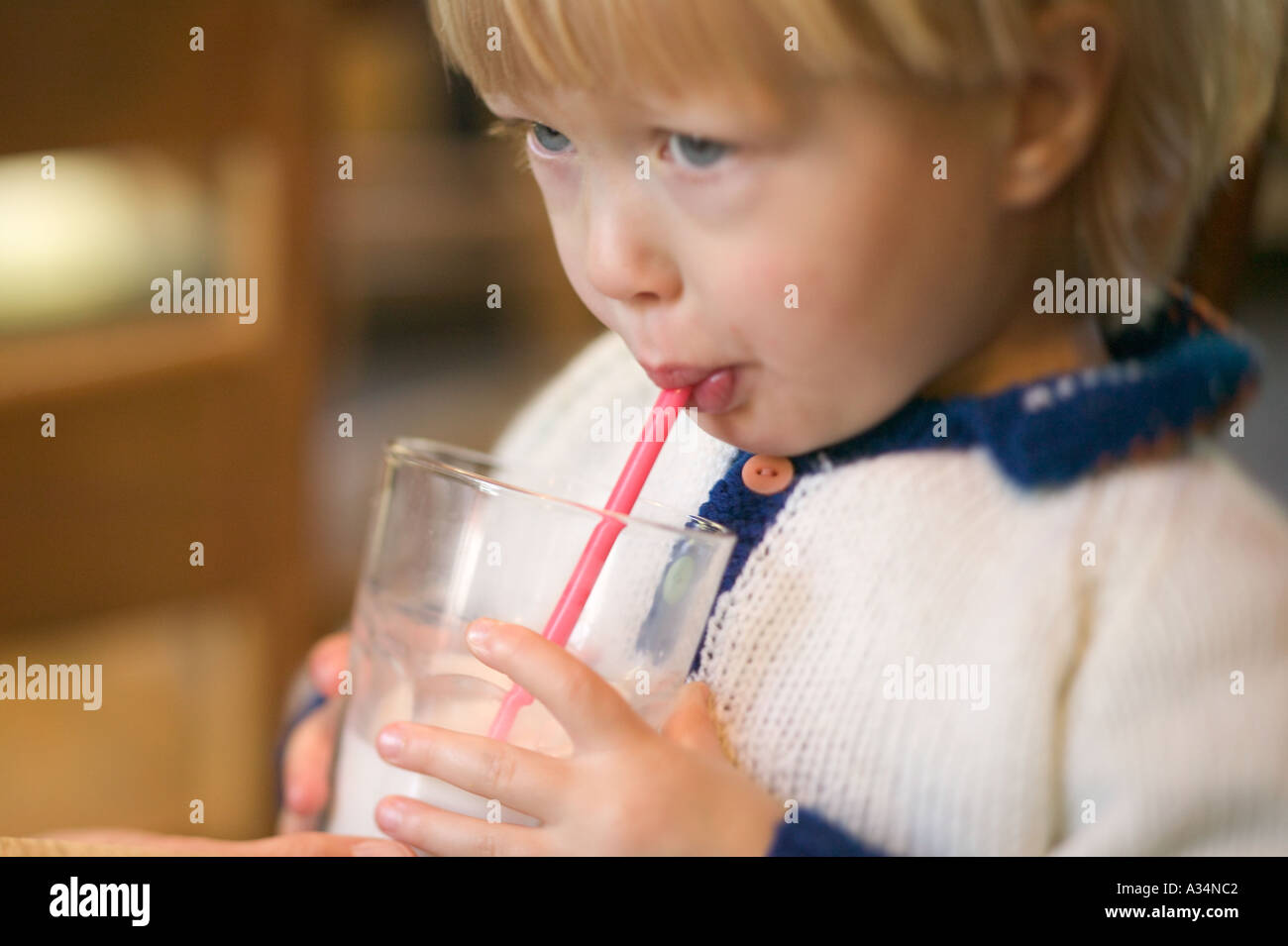Girl drinking milk through straw -Fotos und -Bildmaterial in hoher ...