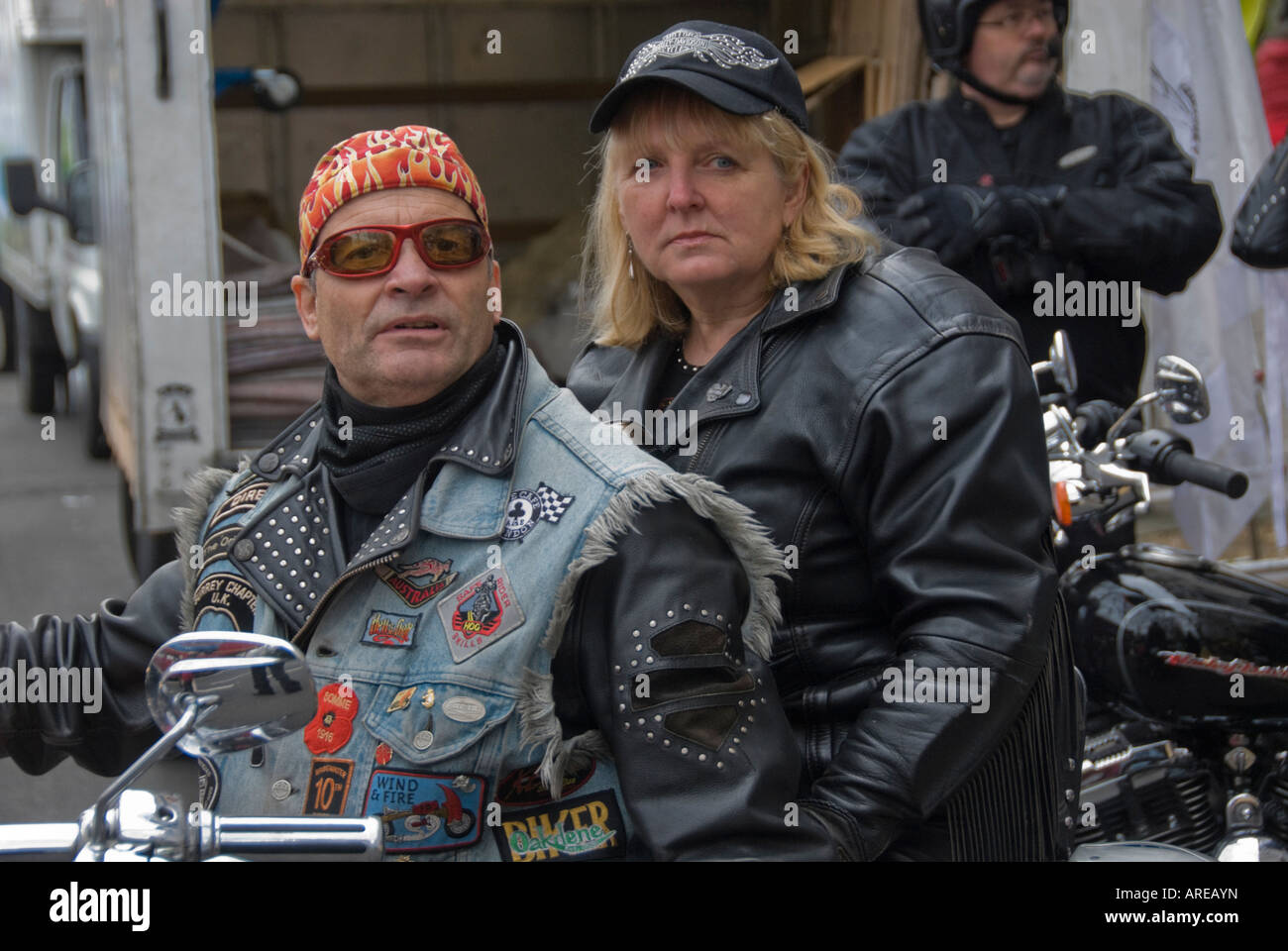 Mann und Frau sitzen auf dem Motorrad, Frau als Sozius, beide in ...