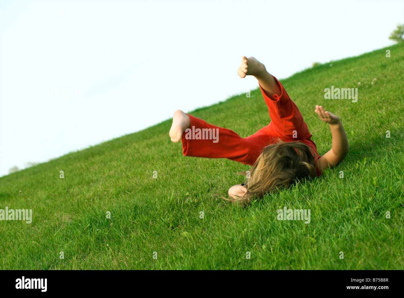 Children Rolling Down Hill Stockfotos & Children Rolling Down Hill ...