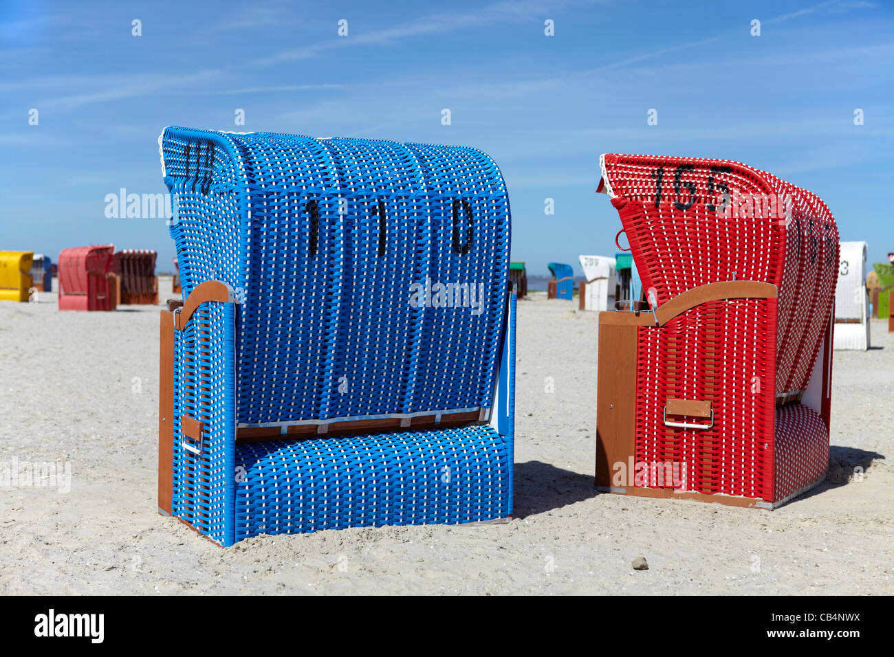 Eine blaue und eine rote Strandkorb am Strand in der Nordsee ...