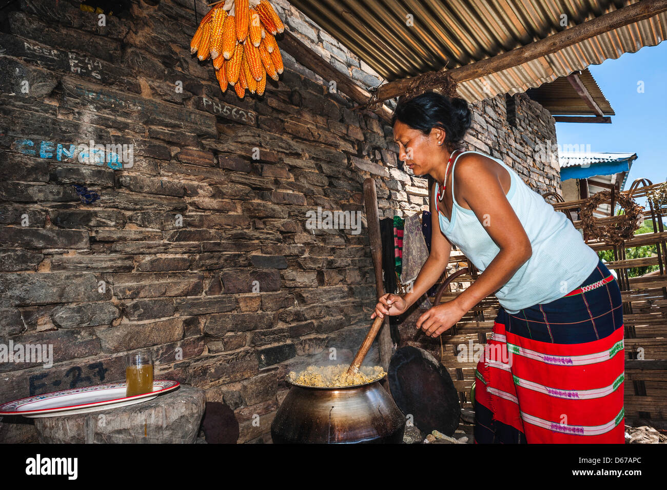 Monpa Frau kocht Mais in der ersten Phase bei der Herstellung von Ara ...