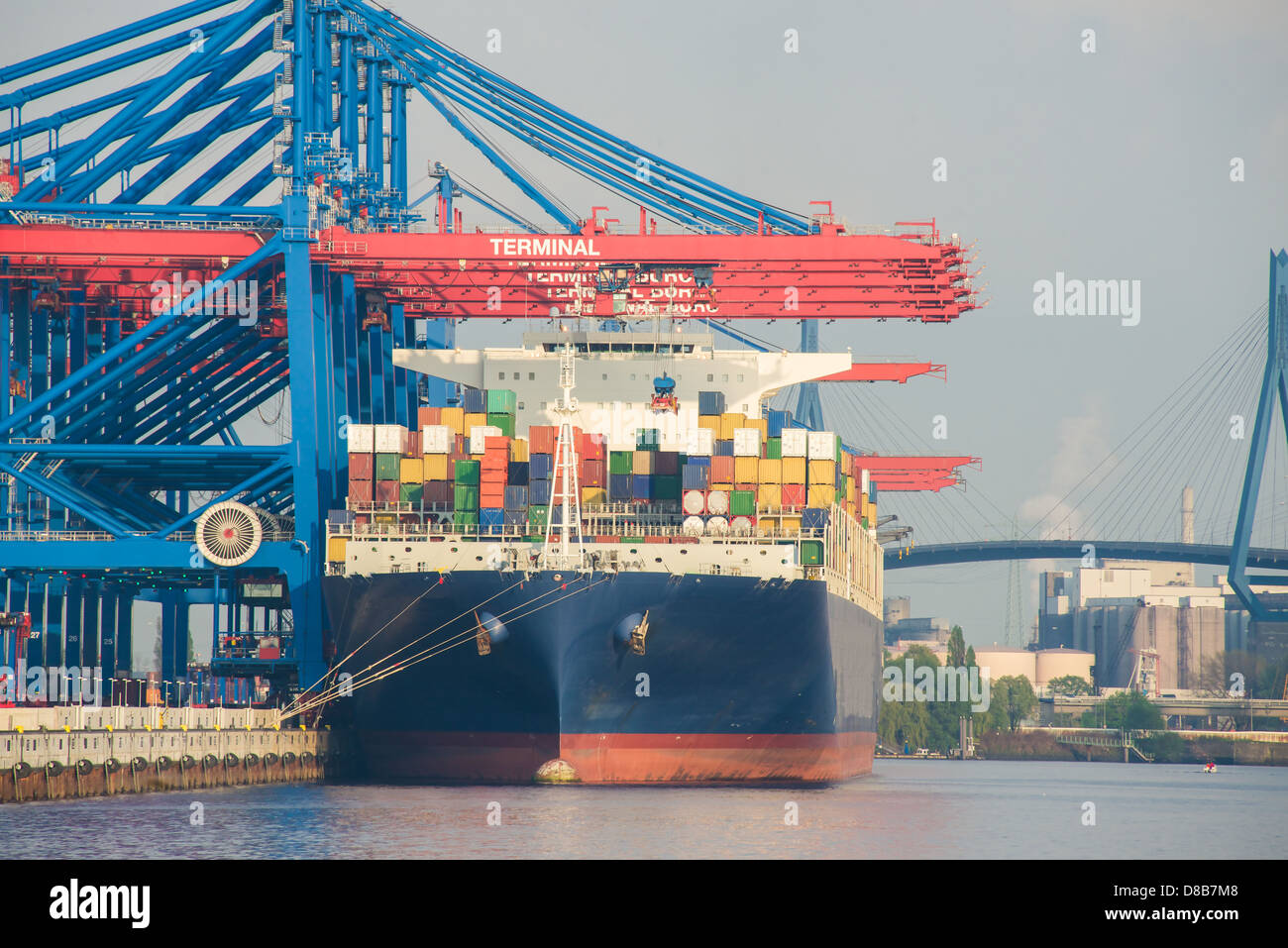 ein großes Containerschiff ist im Hafenterminal mit Containern geladen ...