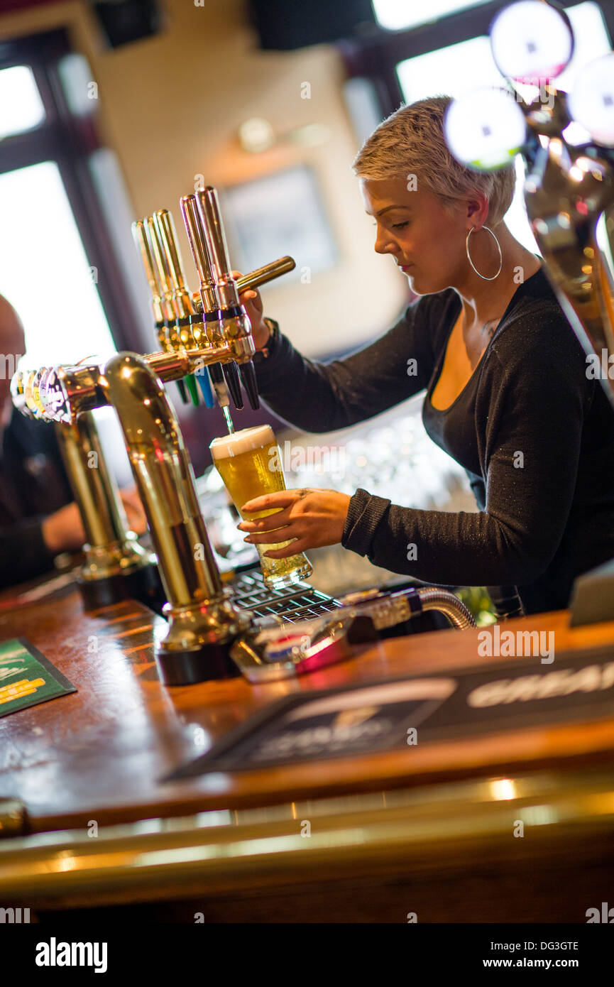 Eine junge Frau weibliche Bardame Bar Arbeitskraft gießen, ziehen einen ...
