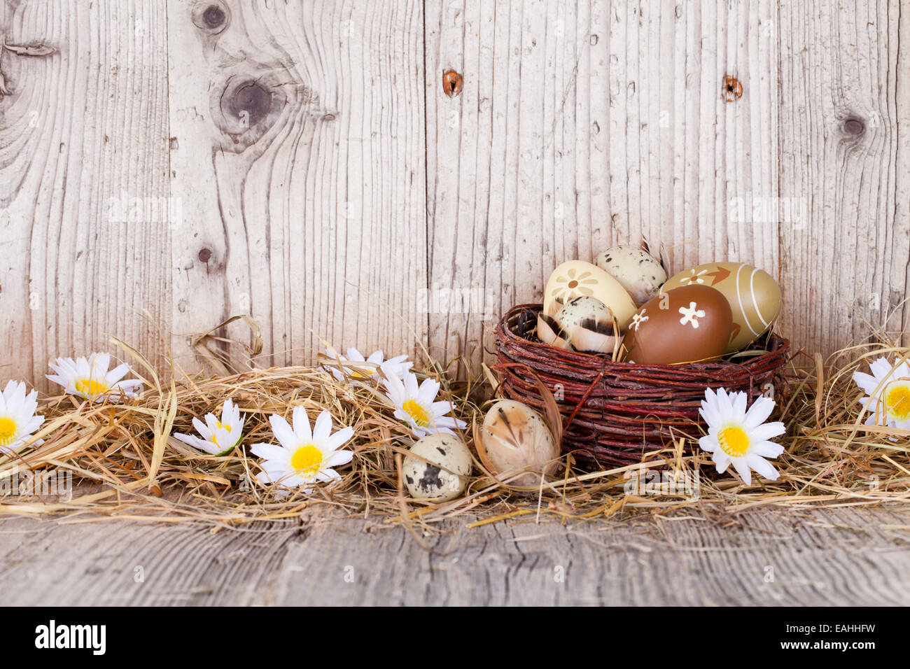 Ostern-Stillleben mit traditionellen dekorativen Eiern im Stroh ...