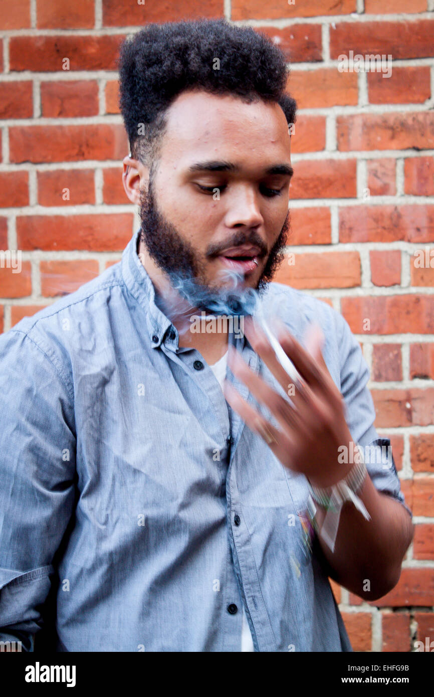 Young man smoking model released -Fotos und -Bildmaterial in hoher ...
