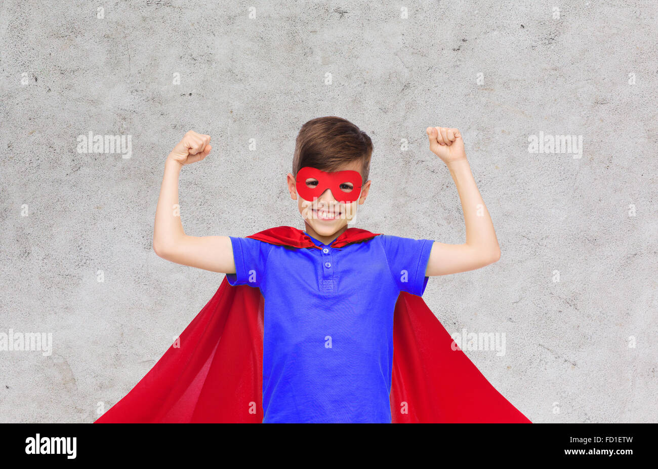 Junge im roten Superhelden Cape und Maske zeigt Fäuste Stockfotografie ...
