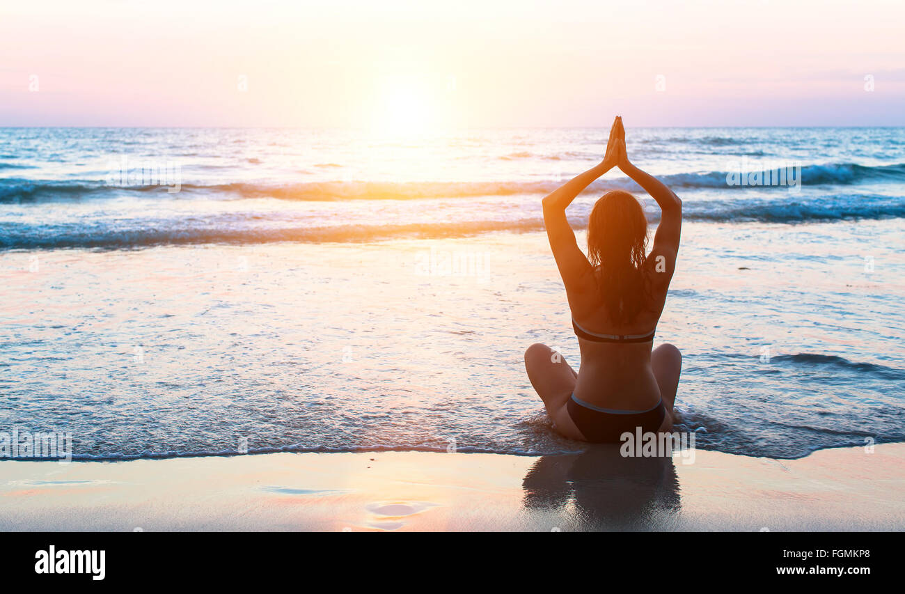 Silhouette Frau praktizieren Yoga am Strand bei Sonnenuntergang ...