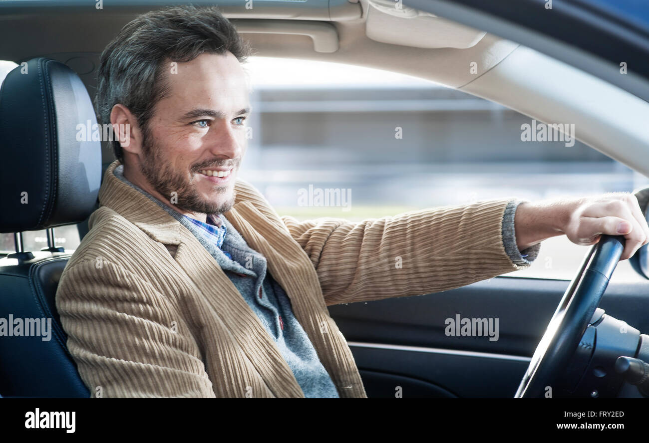 Young man driving expensive car -Fotos und -Bildmaterial in hoher ...