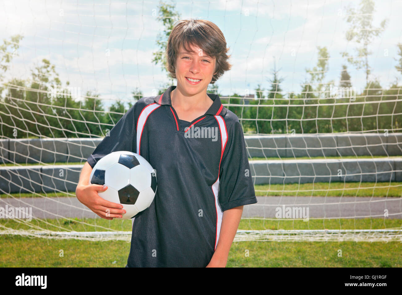 Ein Fußball-Spieler auf dem Spielfeld. Der junge einen Ball halten ...