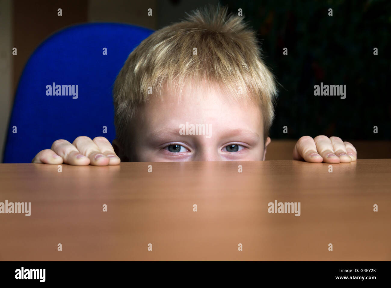 Verspielte junge Kind versteckt sich unter dem Tisch Stockfotografie ...